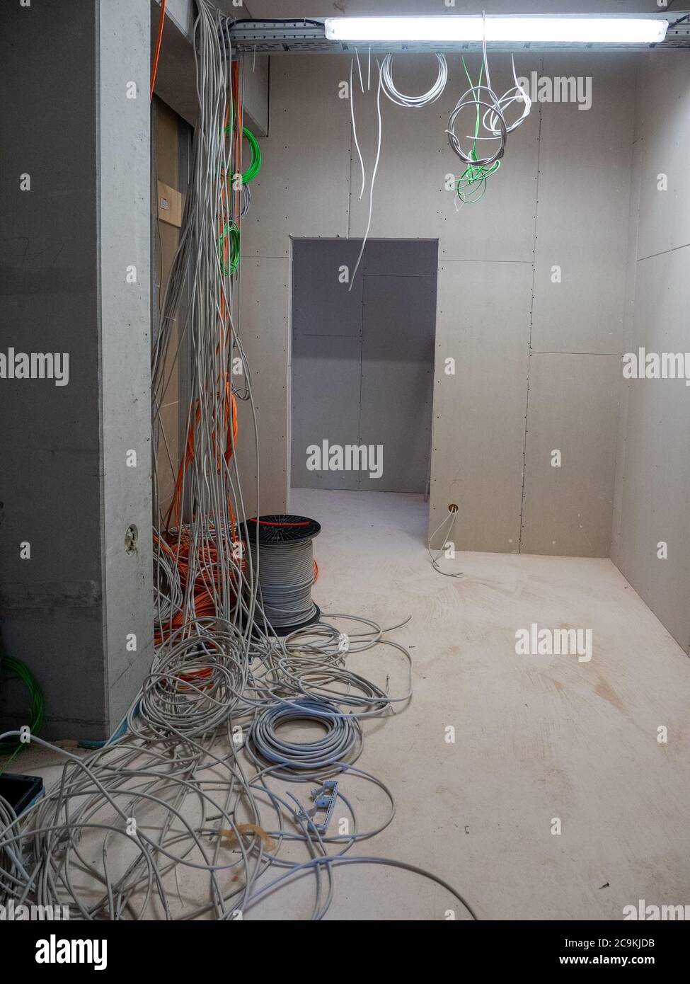 on a construction site many network and power cables hang from the ...