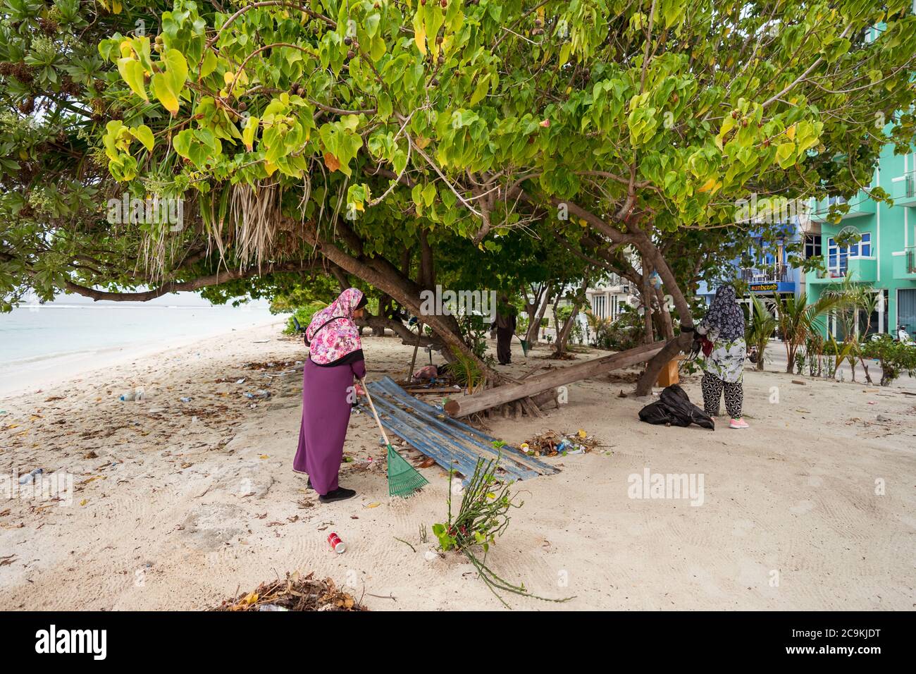 Hulumale / Maldives - August 20, 2019: muslim woman with hijab sweeping ...
