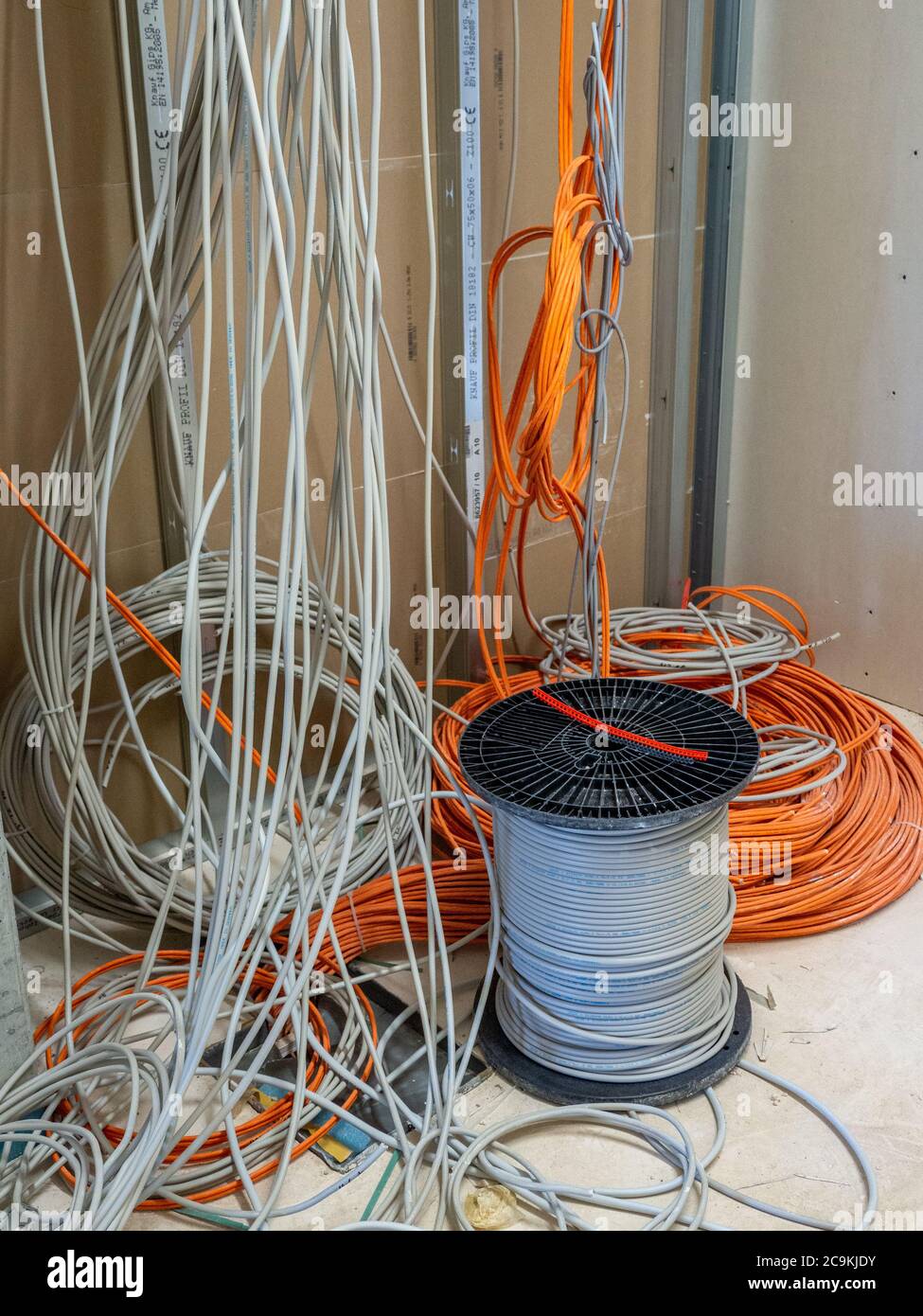 on a construction site many network and power cables hang from the ...