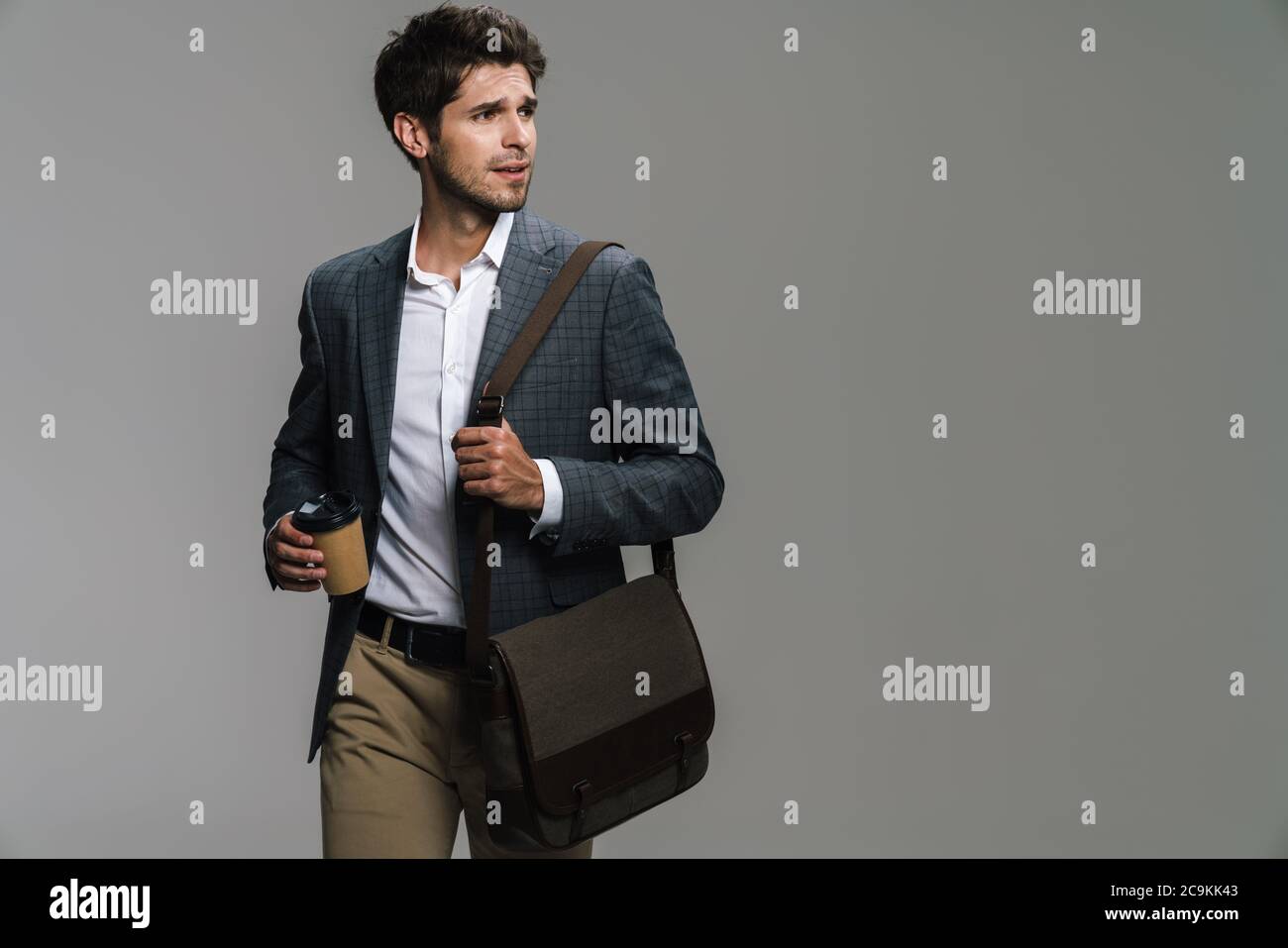Photo of respectable confident businessman with bag drinking coffee ...
