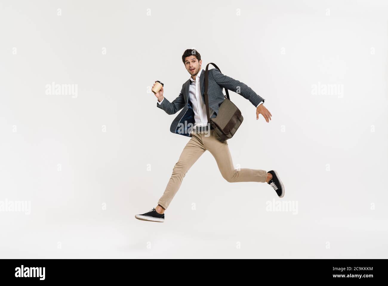 Photo of surprised caucasian businessman drinking coffee while running ...