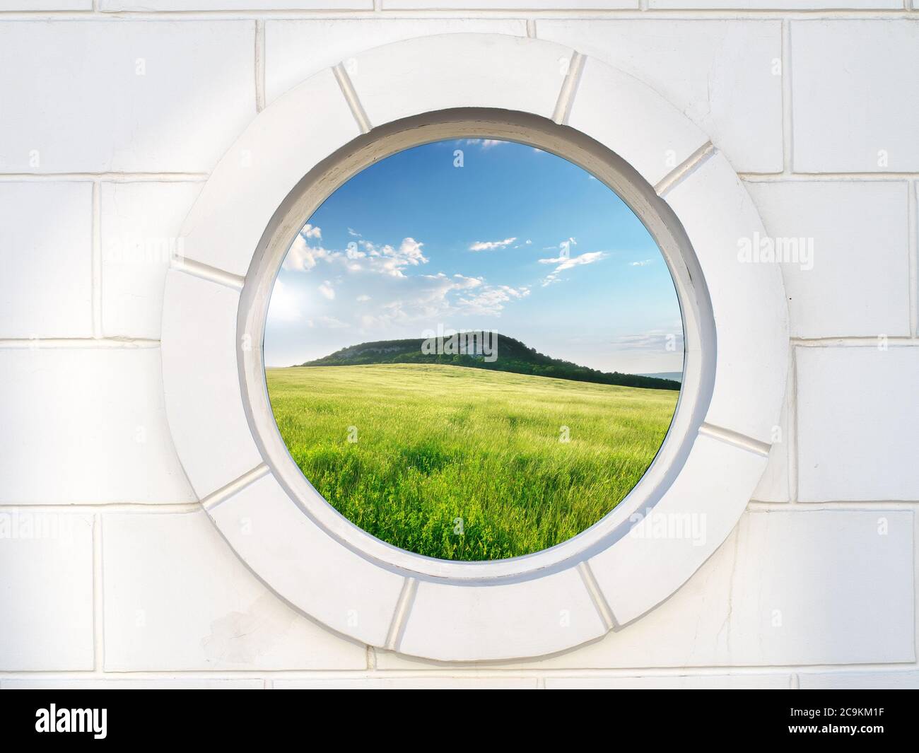 Old white antique round window on wall from stones. Element of design ...