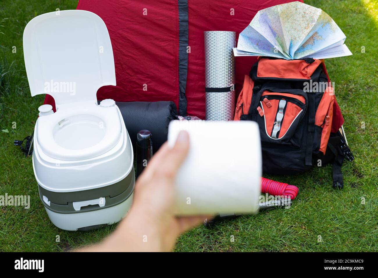 Picture of camping tools on the grass - backpack, tent, gas tank, cans ...