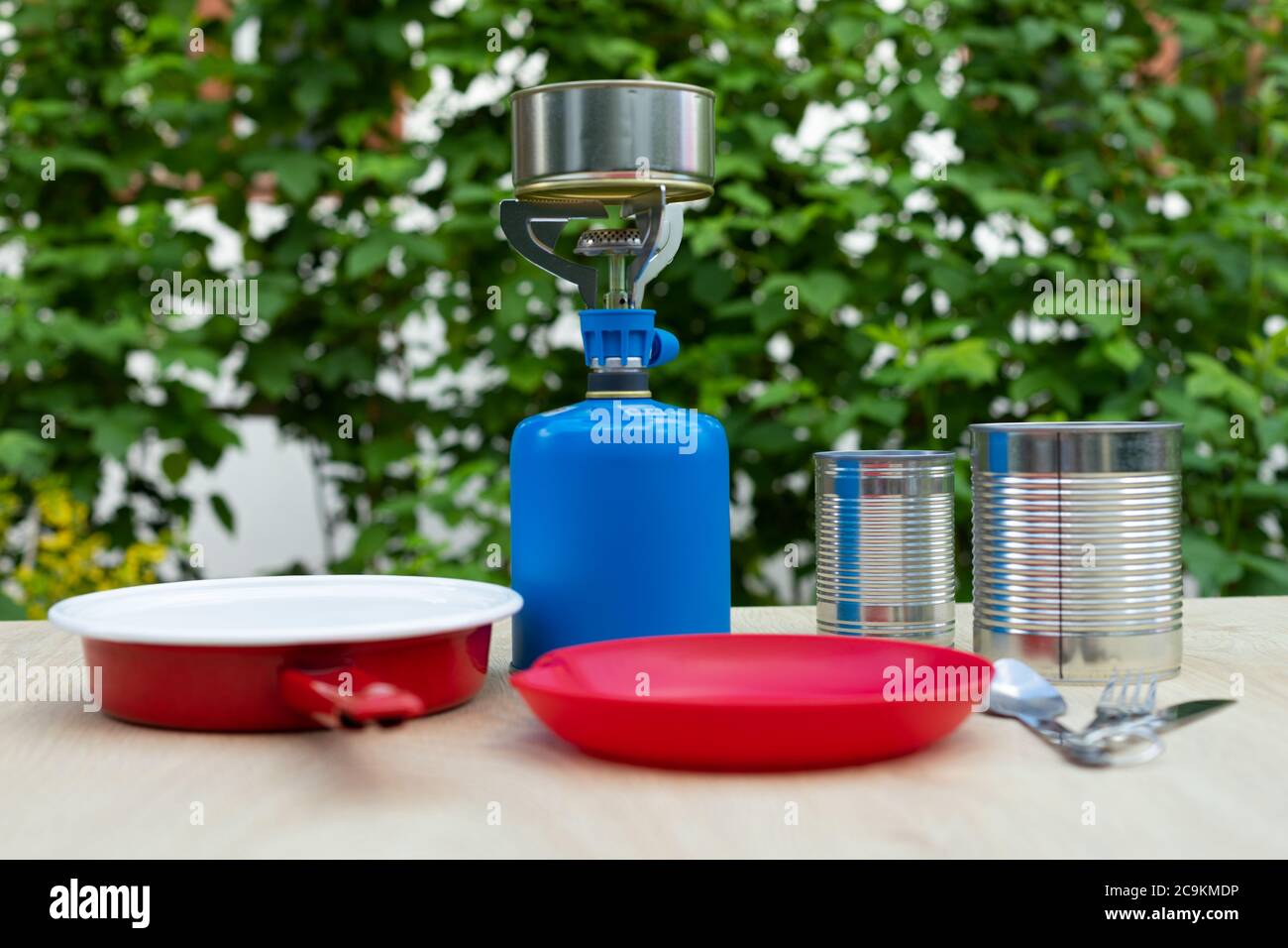 Picture of camping tools on a table - gas tank, cans, etc - ready to go ...