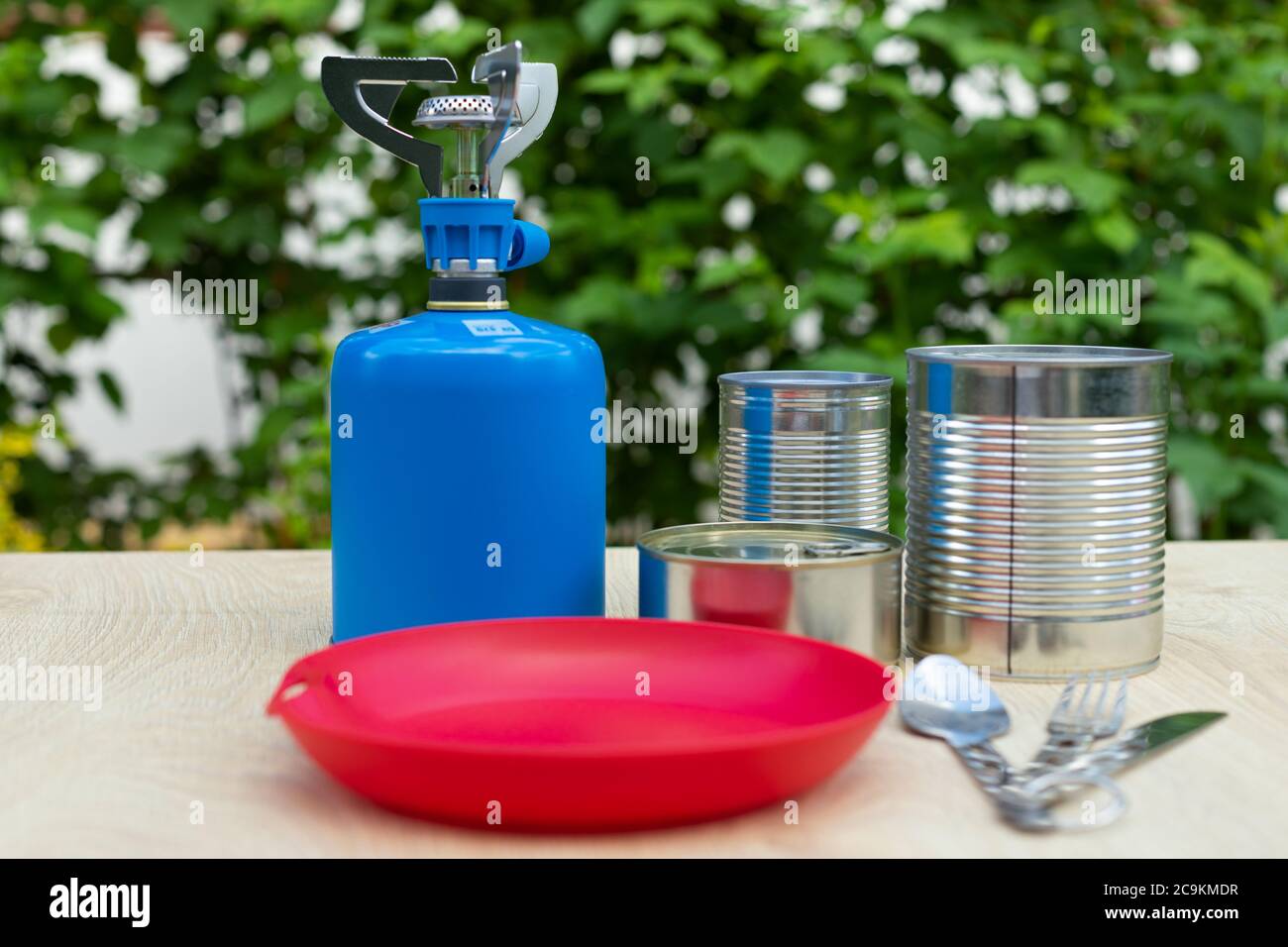 Picture of camping tools on a table - gas tank, cans, etc - ready to go ...