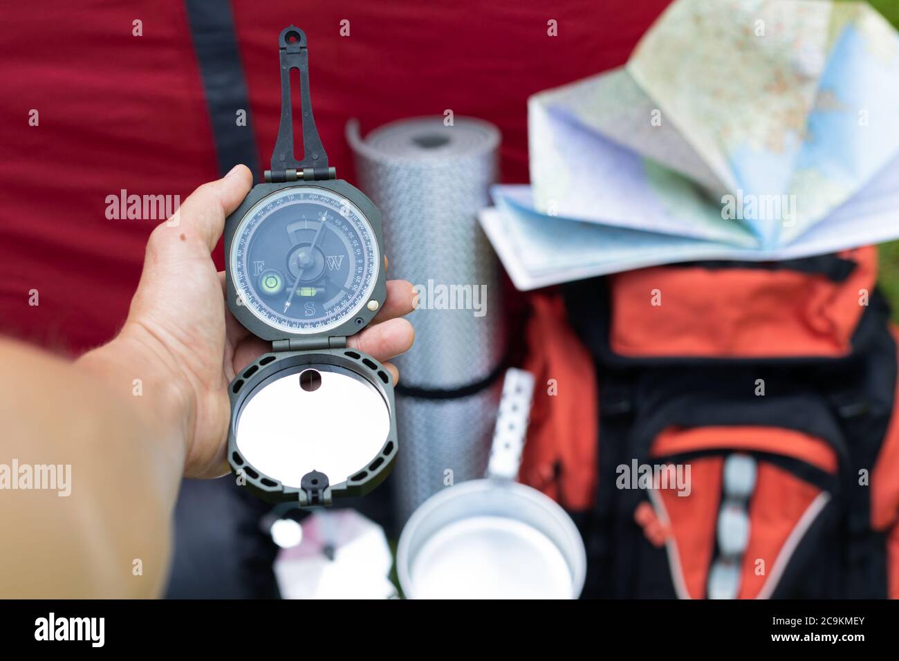 Picture of camping tools on the grass - backpack, tent, gas tank, cans ...