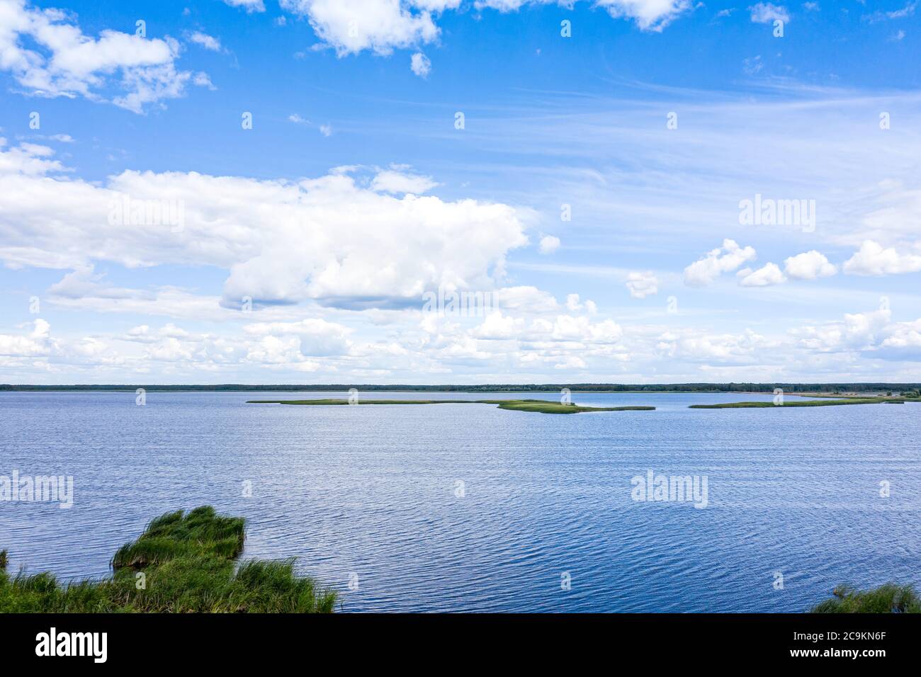 aerial view of blue lake and forest on horizon with beautiful ...