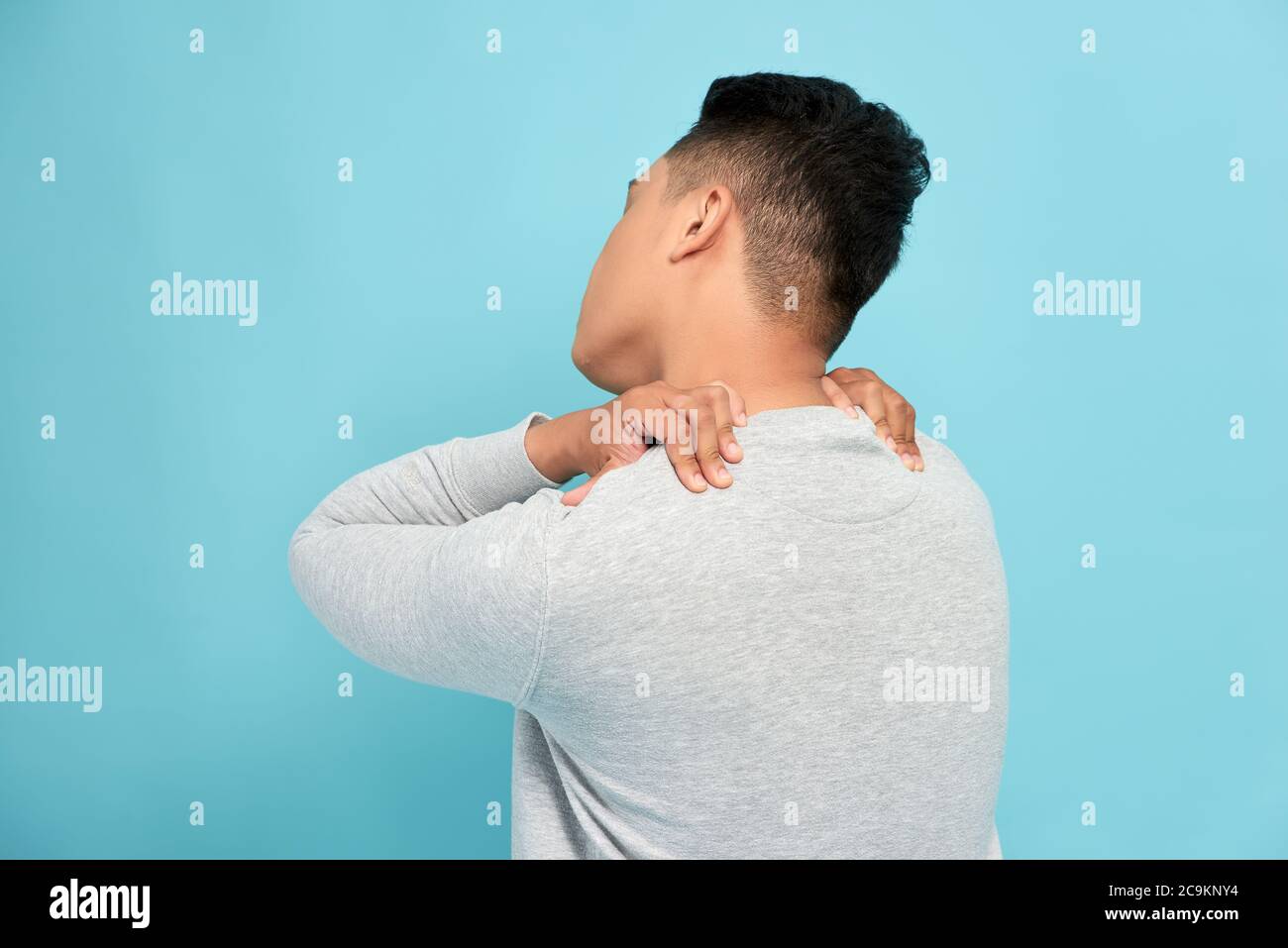 Young attractive man having shoulder pain Stock Photo - Alamy