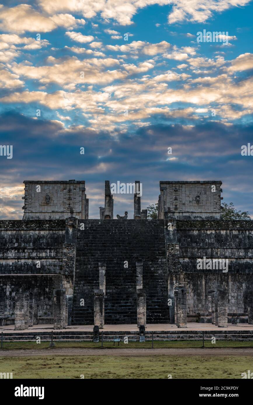A statue of Chac Mool flanked by two Kukulkan serpent pillars atop the ...