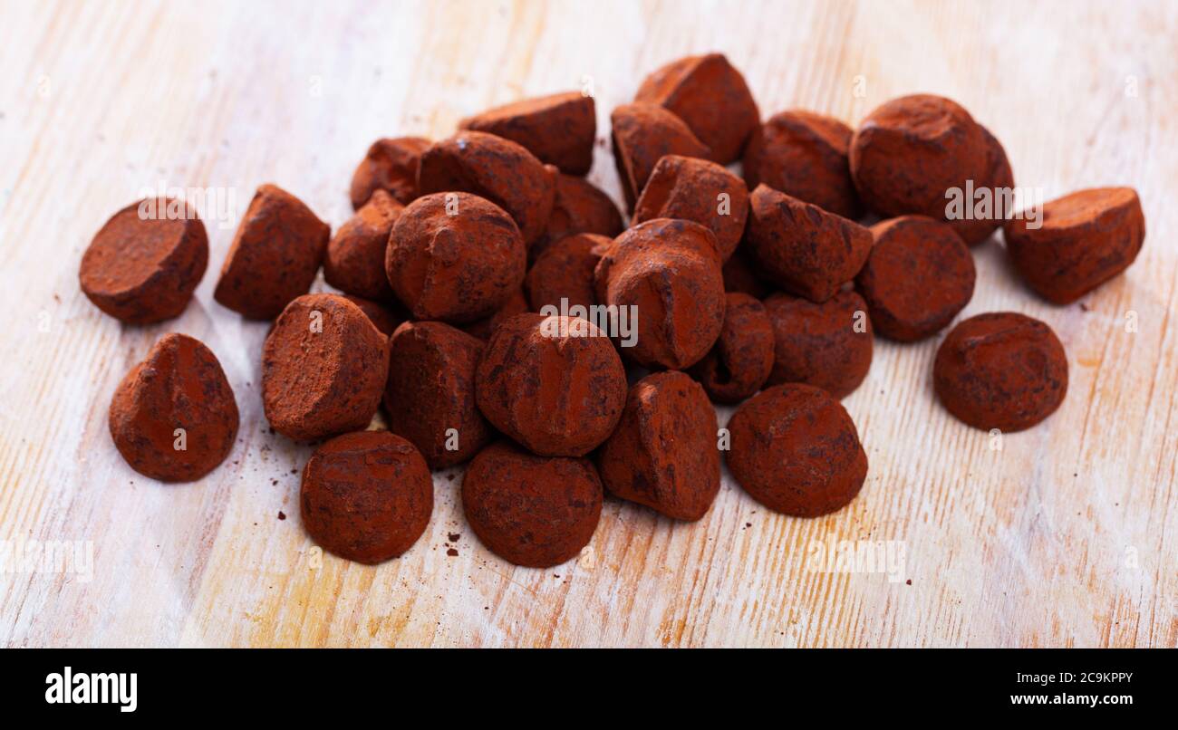 Group of chocolate truffle candies sprinkled with cocoa powder on ...
