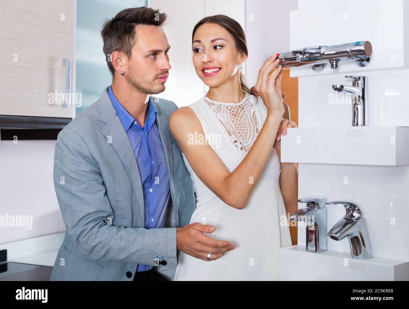 Happy cheerful young family couple looking for modern functional mixer ...