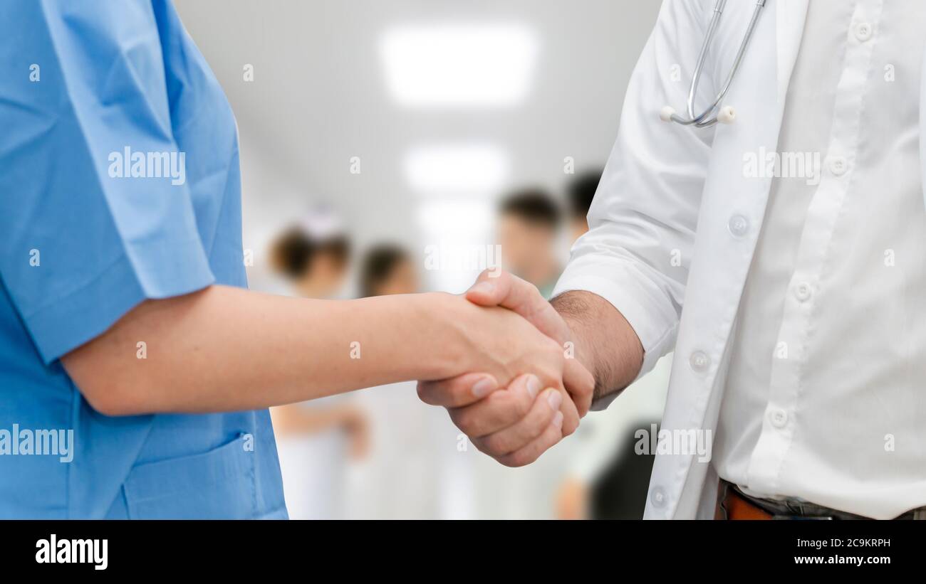 Doctor in hospital handshake with another doctor Stock Photo - Alamy