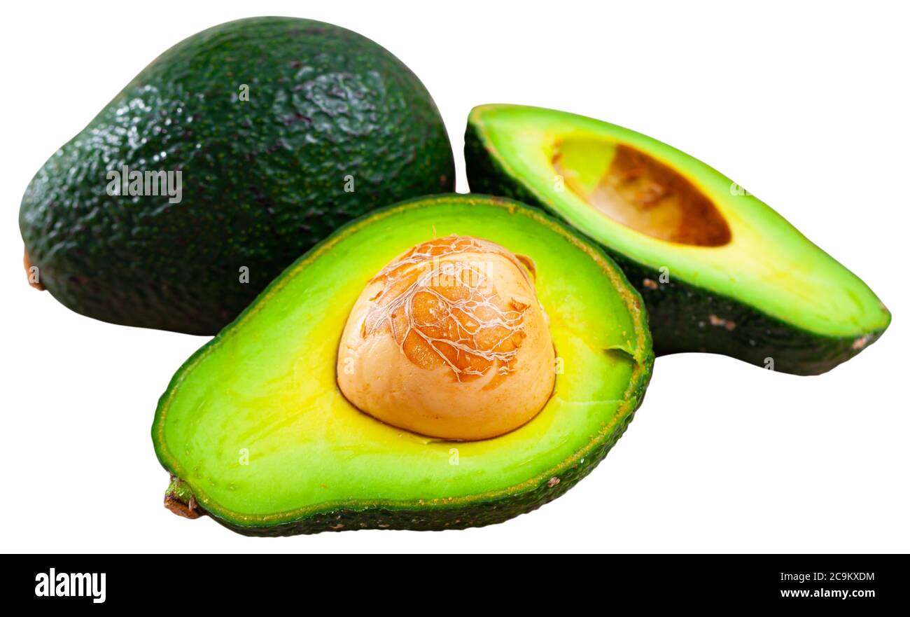 Whole and cut in half ripe organic avocados. Healthy vitamin nutrition ...