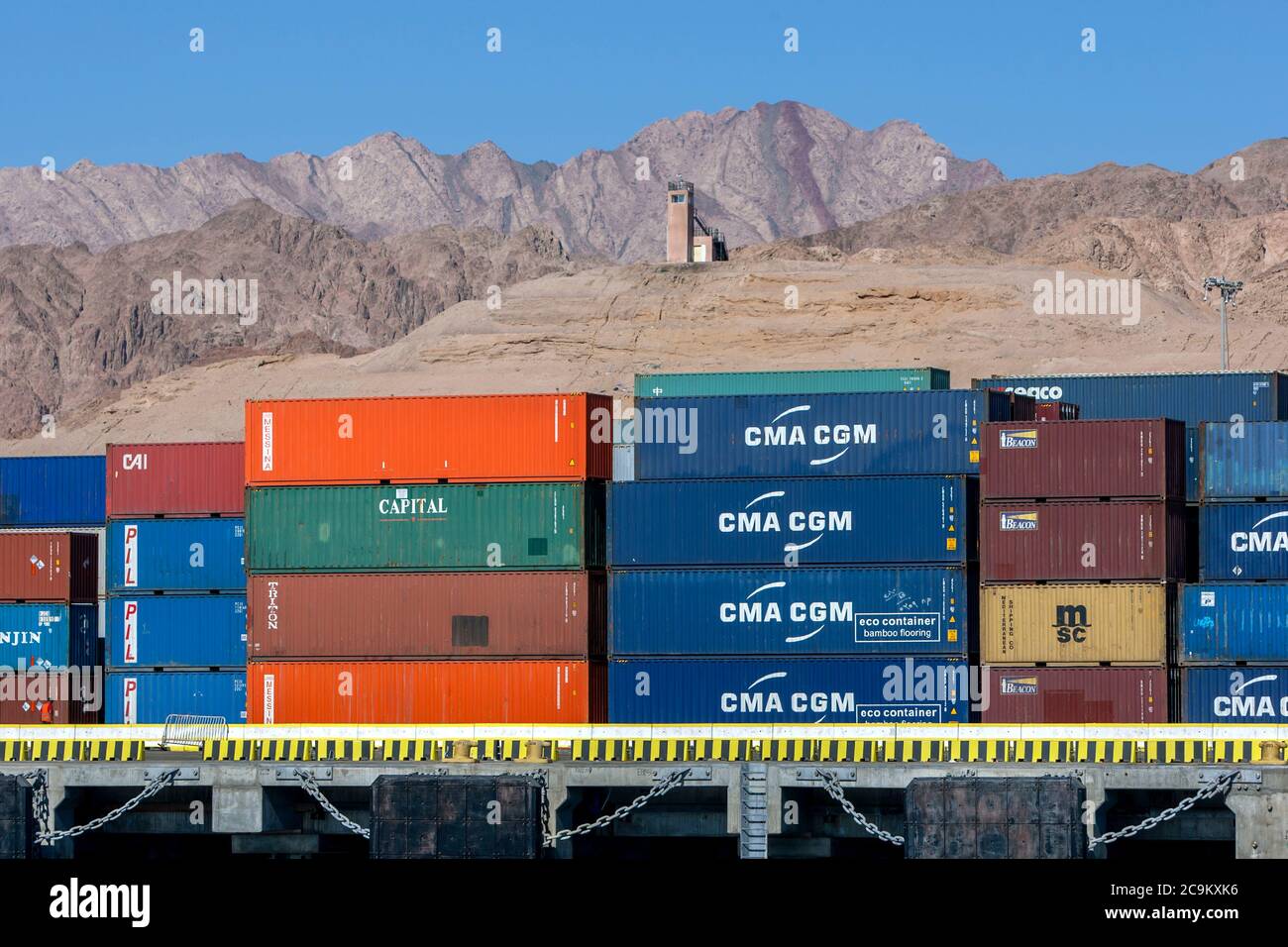 A row of shipping containers sit on the dock at the Aqaba Container ...