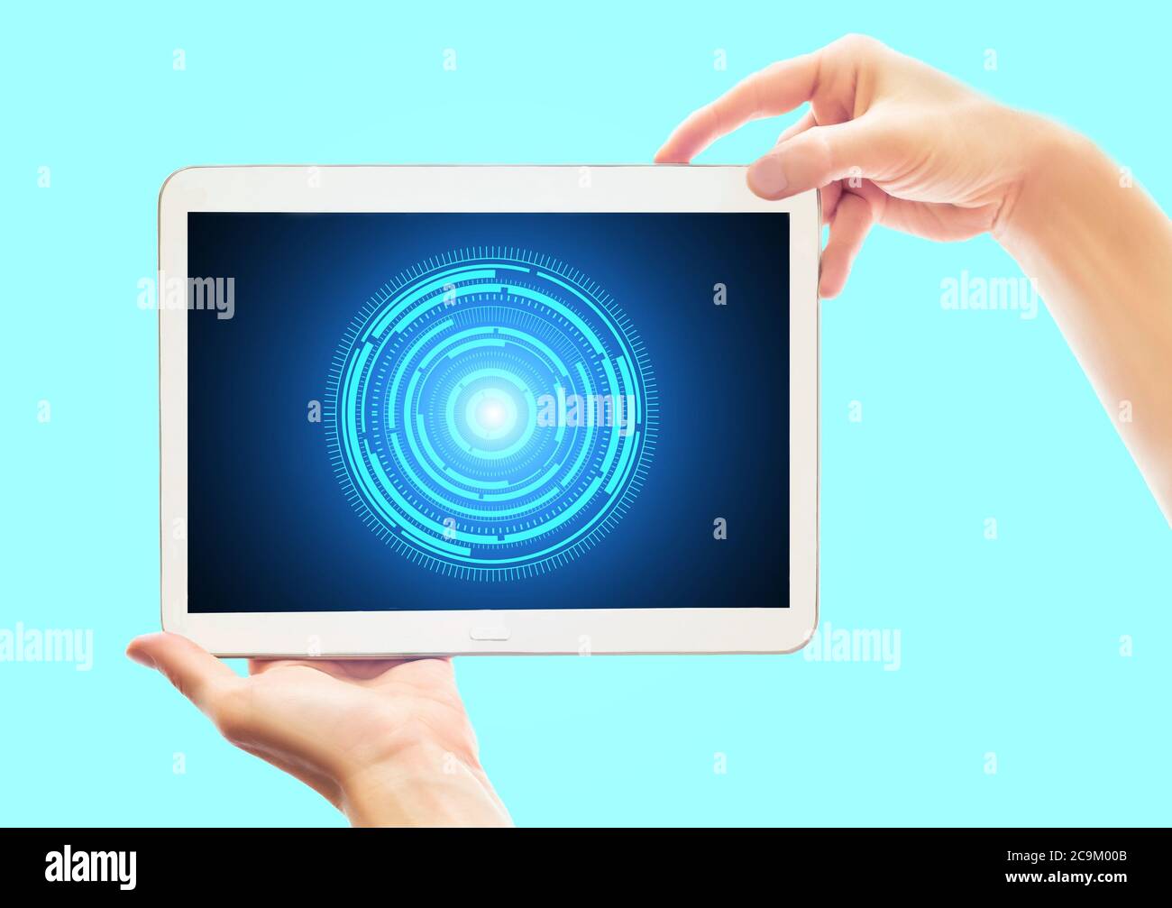Hands holding working tablet isolated on pastel background. Cyber ...