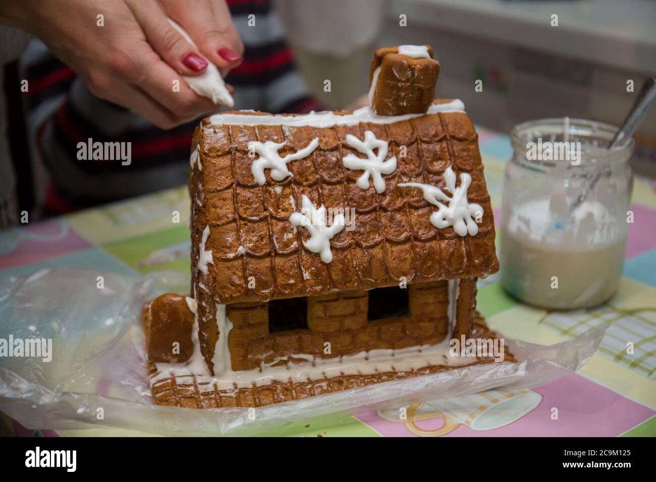 making a gingerbread house on kitchen table Stock Photo - Alamy