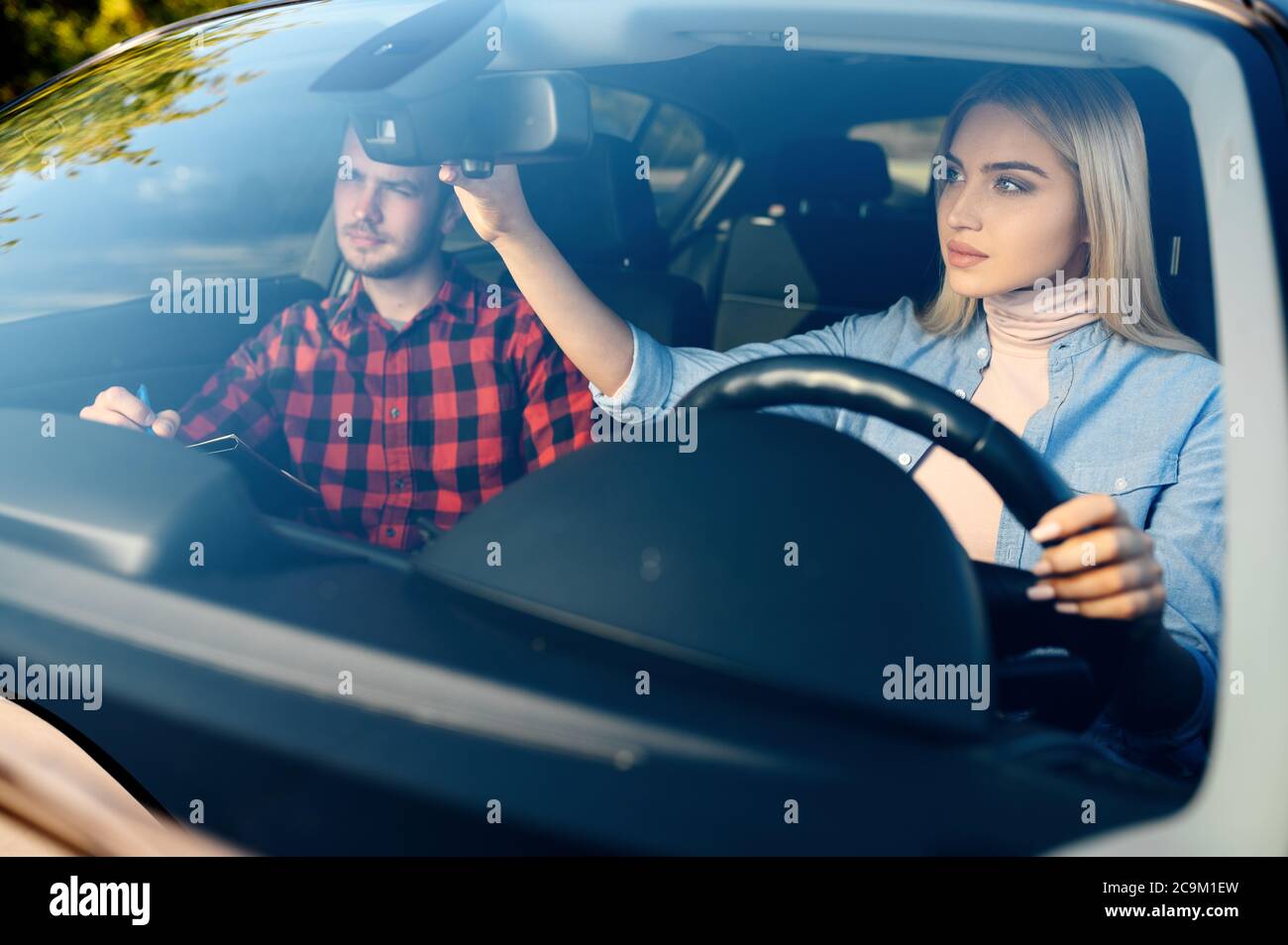 Lady and male instructor in car, driving school Stock Photo - Alamy