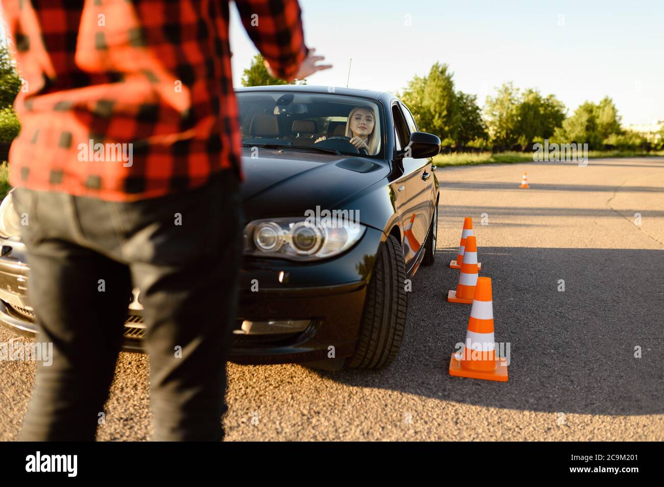 Student passes between cones, driving school Stock Photo - Alamy