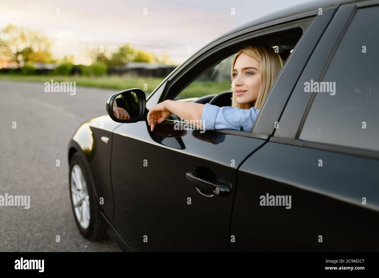 Female student poses in car, driving school Stock Photo - Alamy