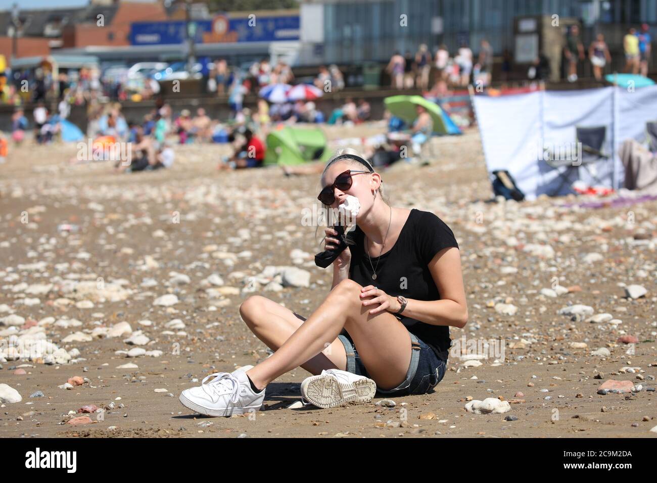 Hunstanton, UK. 31st July, 2020. Mia Wilkinson enjoys an ice cream on ...