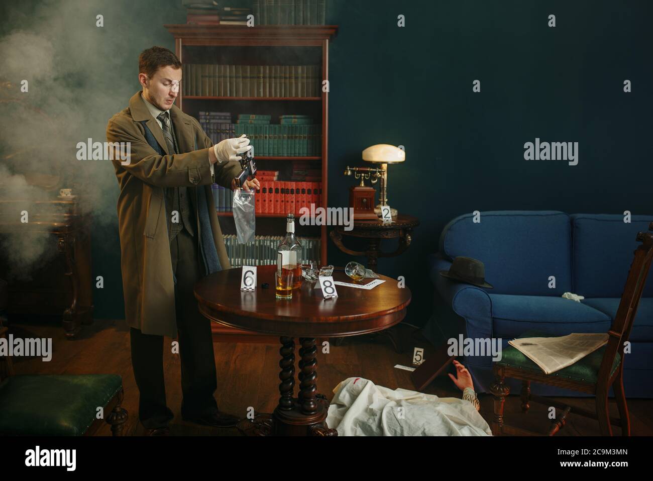 Male detective puts murder weapon in a bag Stock Photo - Alamy