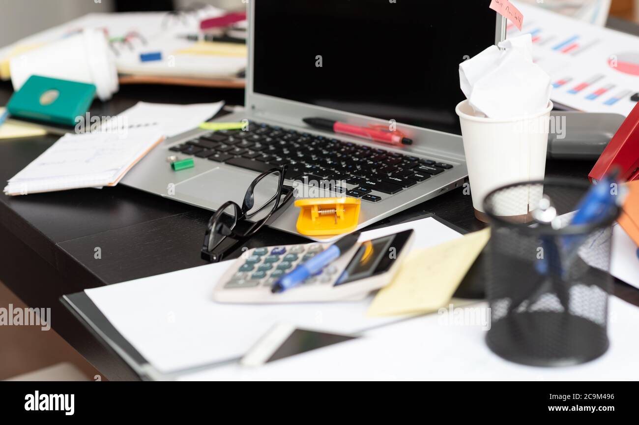 Messy and cluttered office desk Stock Photo - Alamy