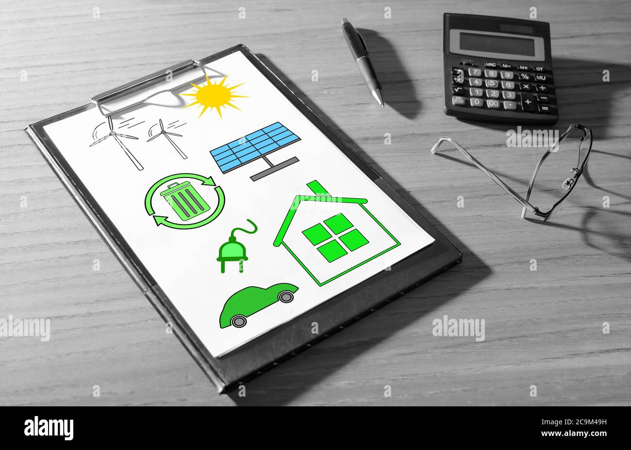 Clean energy concept on a clipboard with a calculator Stock Photo - Alamy