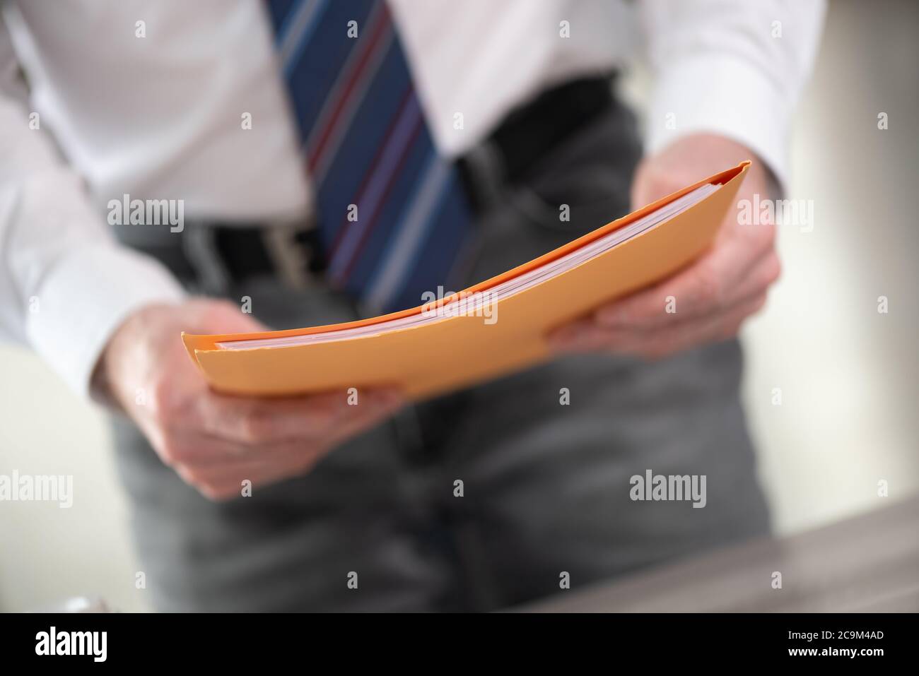 Businessman holding folder with paper documents Stock Photo - Alamy