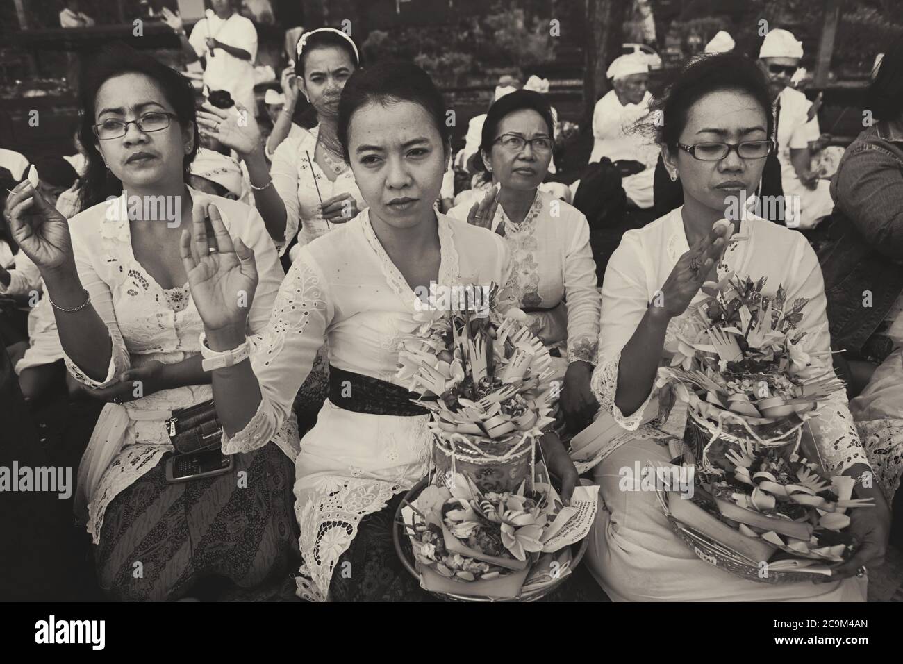 Purifying the spirits: Members of a Balinese family doing a ritual at a ...