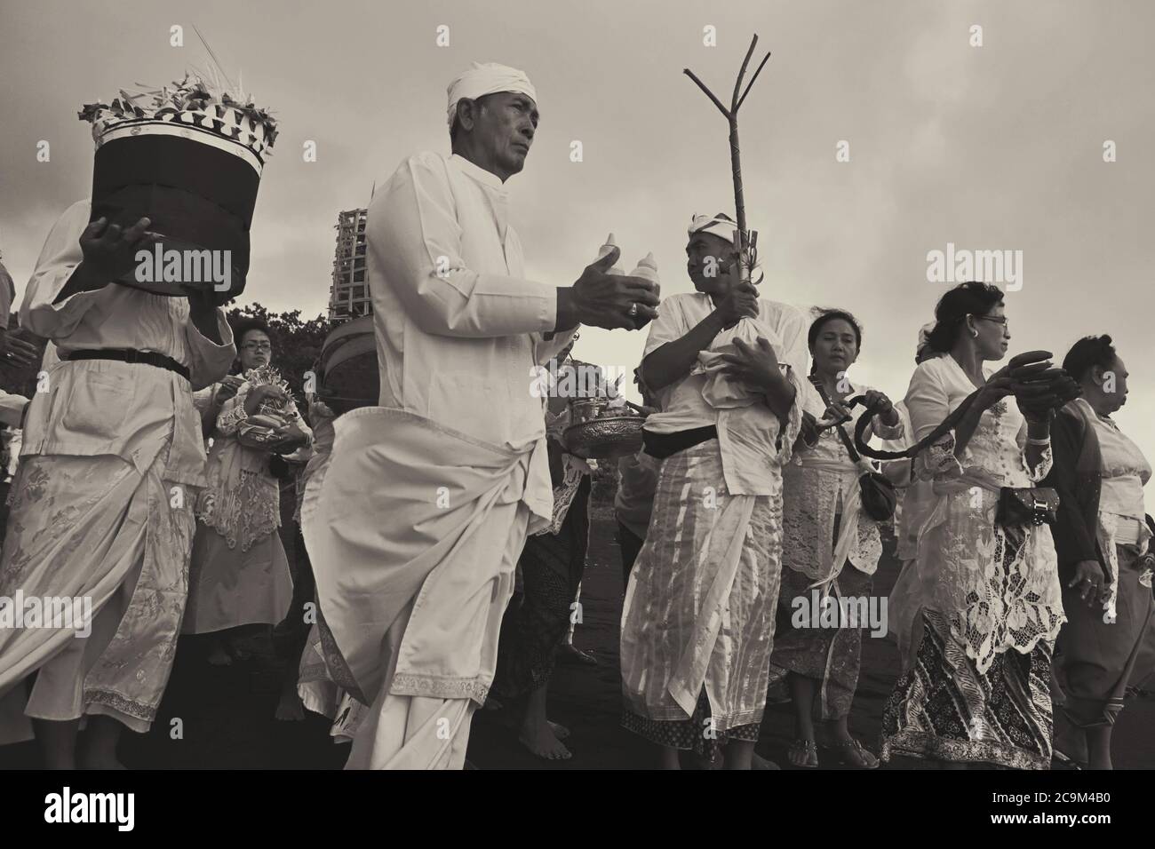 Purifying the spirits: A priest leading the members of a Balinese ...
