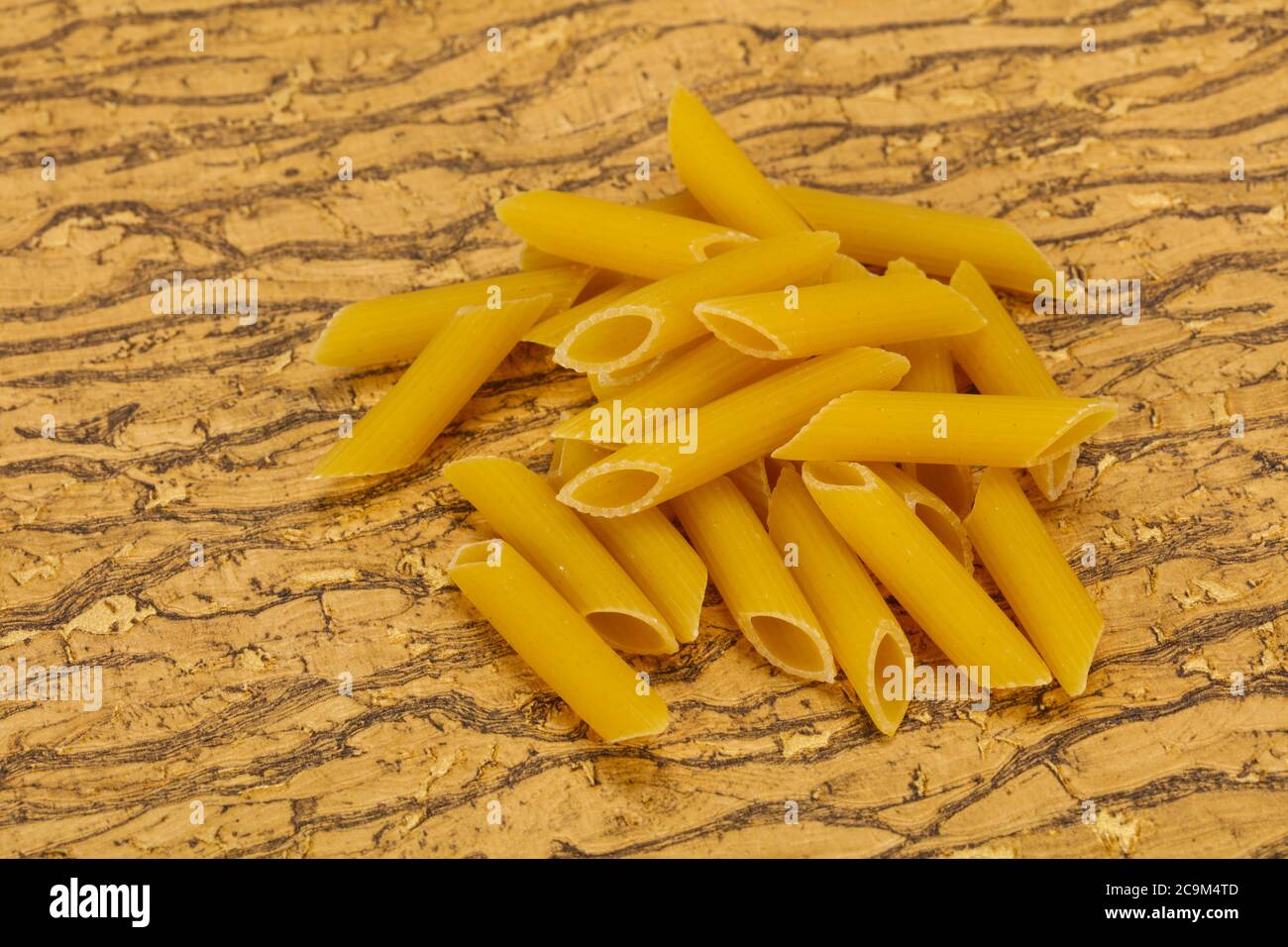 Raw penne pasta ready for bowl Stock Photo - Alamy