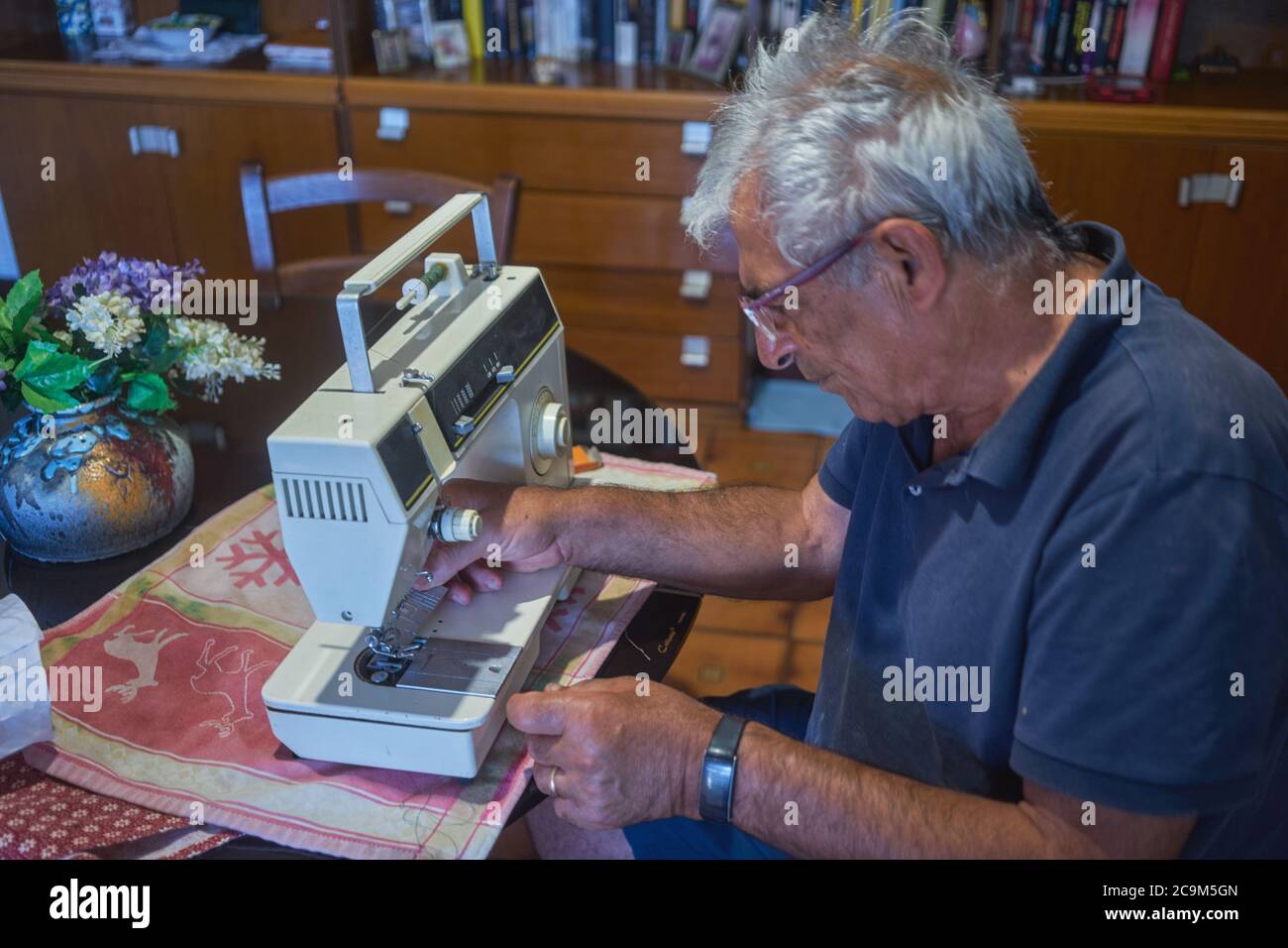 elderly man using a sewing machine Stock Photo - Alamy