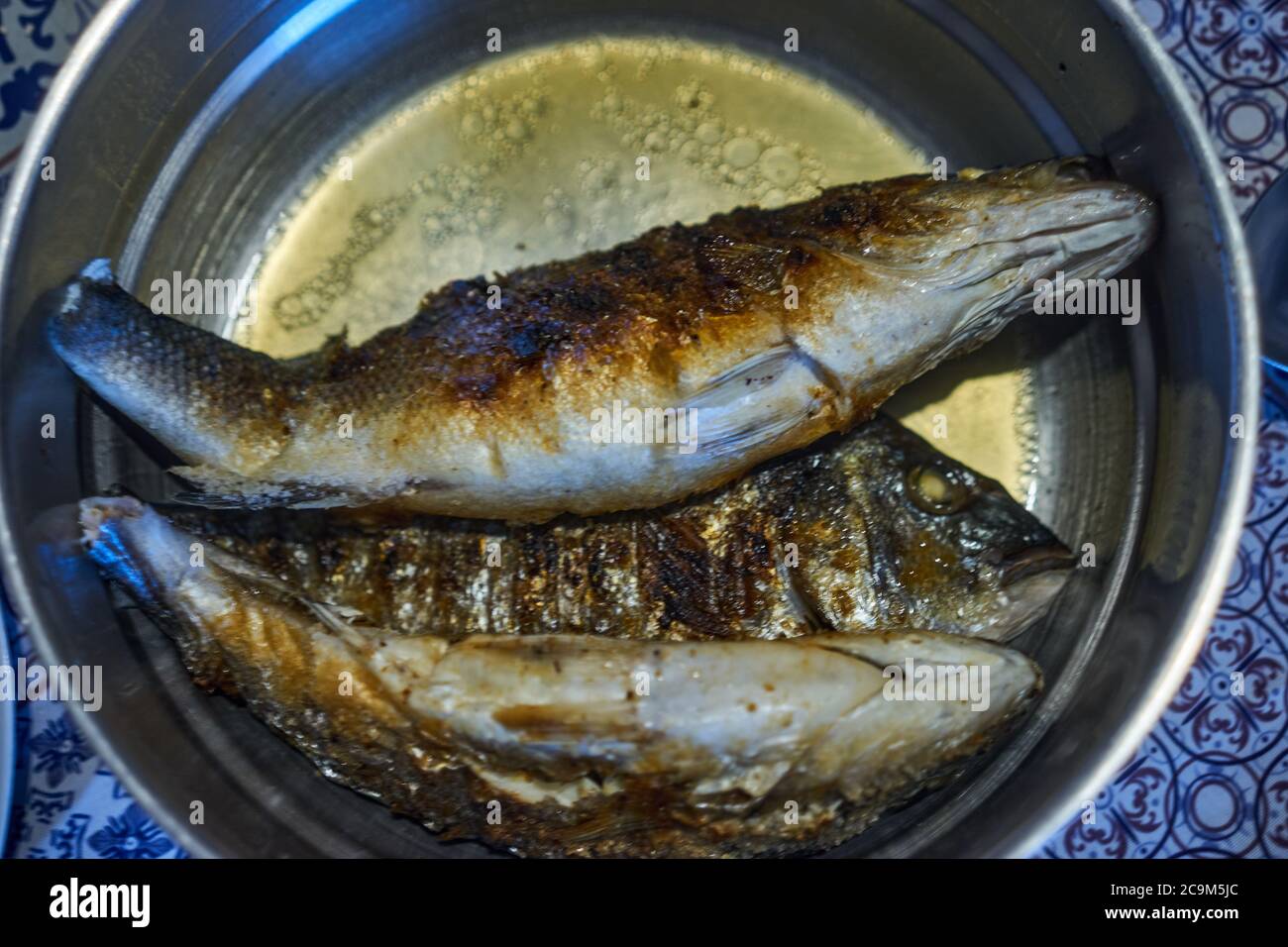 pot with roasted fish Stock Photo - Alamy