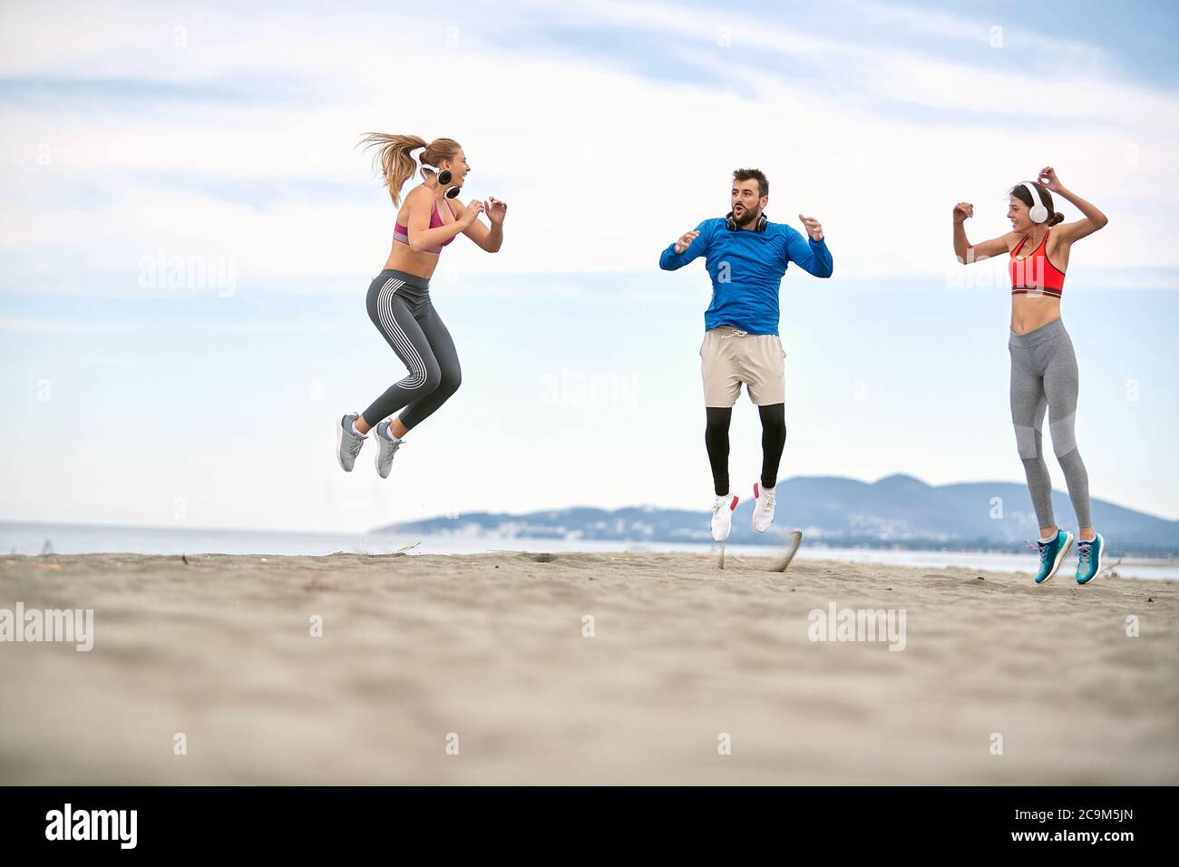Man running jumping on beach hi-res stock photography and images - Alamy