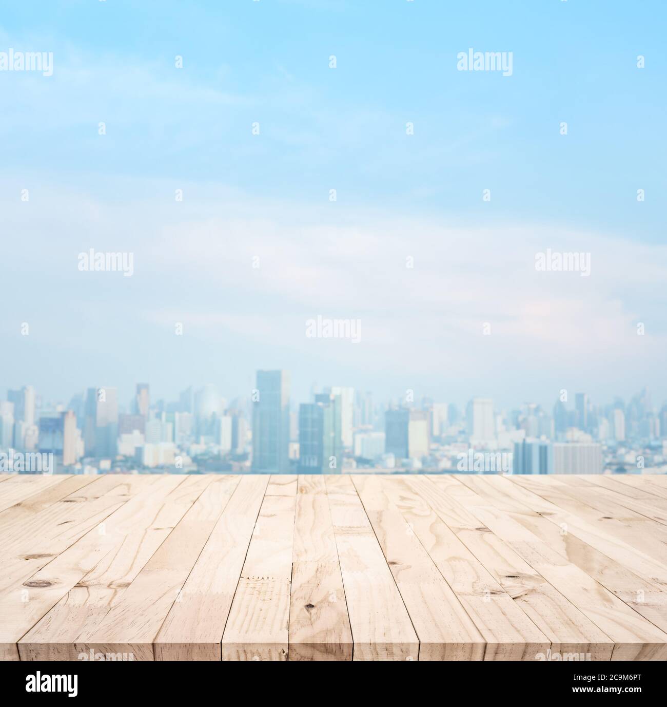 Wood table top on blur city view.For montage product display or design ...