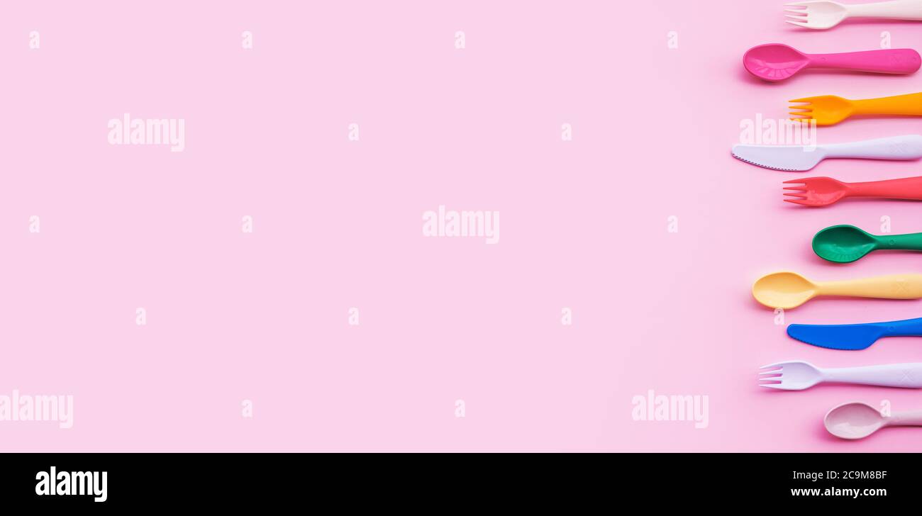 Top view of colorful spoon and fork element on color table.flat lay ...