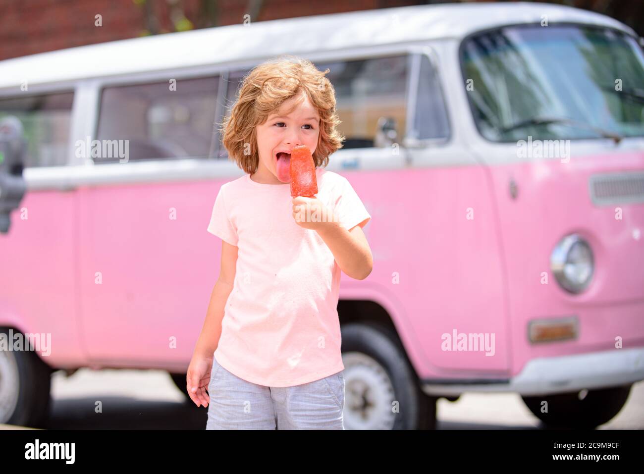 Kids ice cream. Child with frozen dessert in hand. Boy with icecream ...