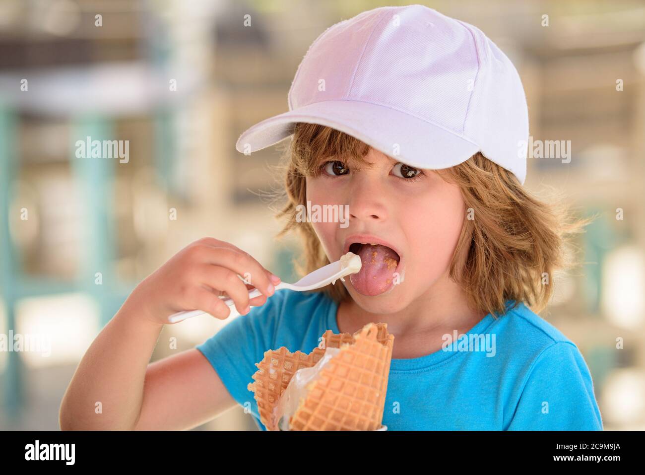 Kid eating ice cream. Cute child licking big icecream in waffles cone ...