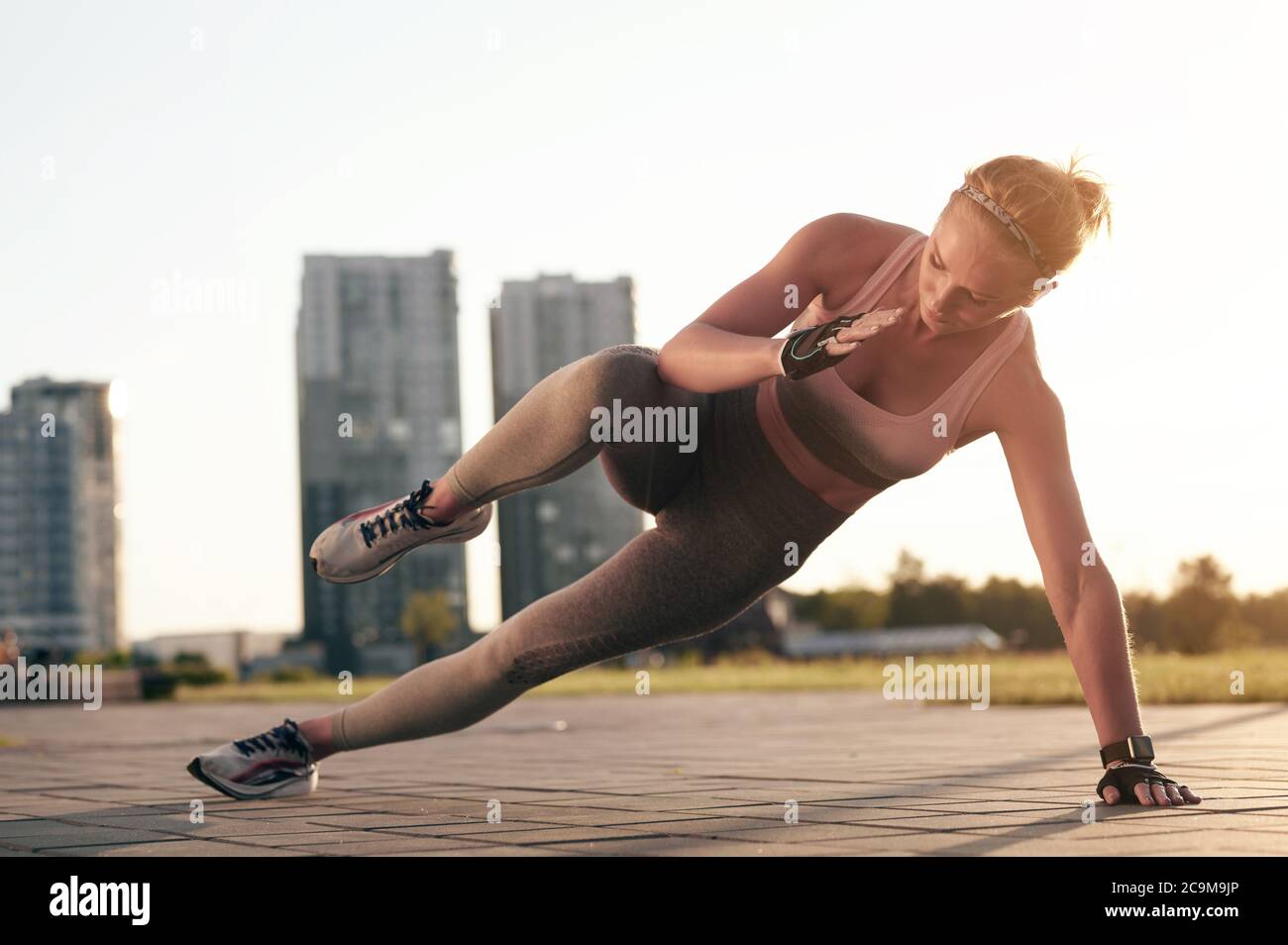 Side plank Fitness exercise. Athletic woman is doing power training ...