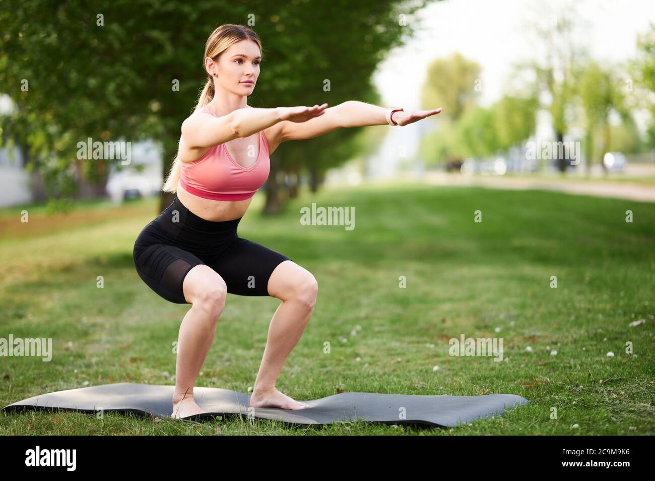 Squats. Sports Woman In fitness clothes squatting. Burn in buttocks ...