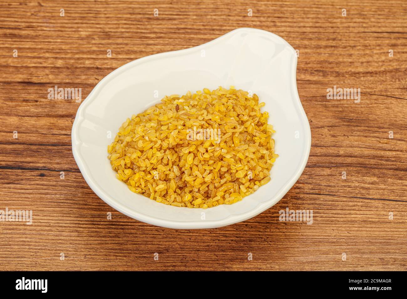 Vegetarian cuisine - dry bulgur for cooking in the bowl Stock Photo - Alamy