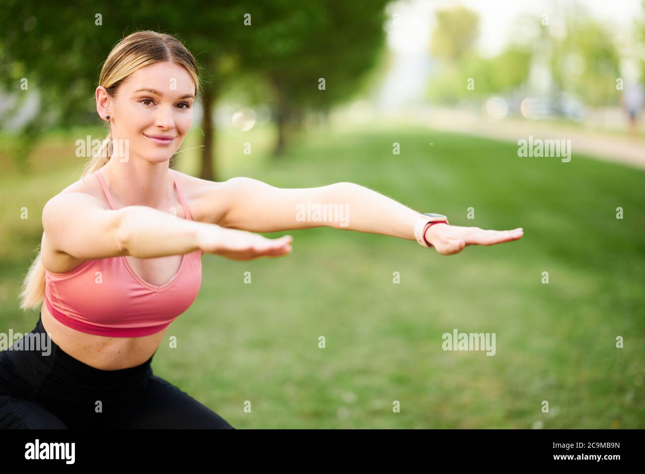 Squats. Sports Woman In fitness clothes squatting. Burn in buttocks ...