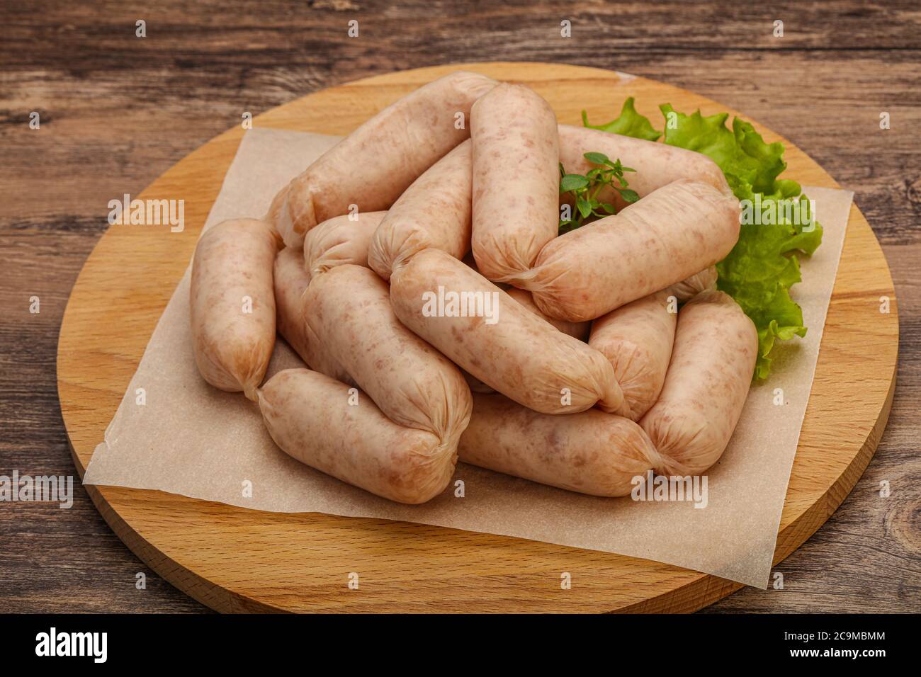 Raw natural chicken baby sausages for roast Stock Photo - Alamy