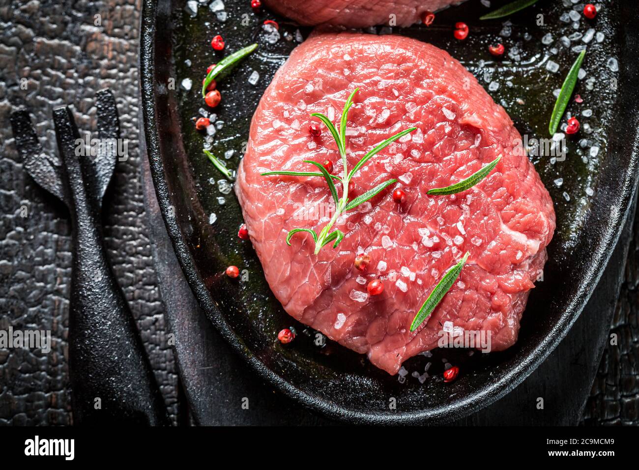 Grilling red meat with rosemary and pepper Stock Photo - Alamy
