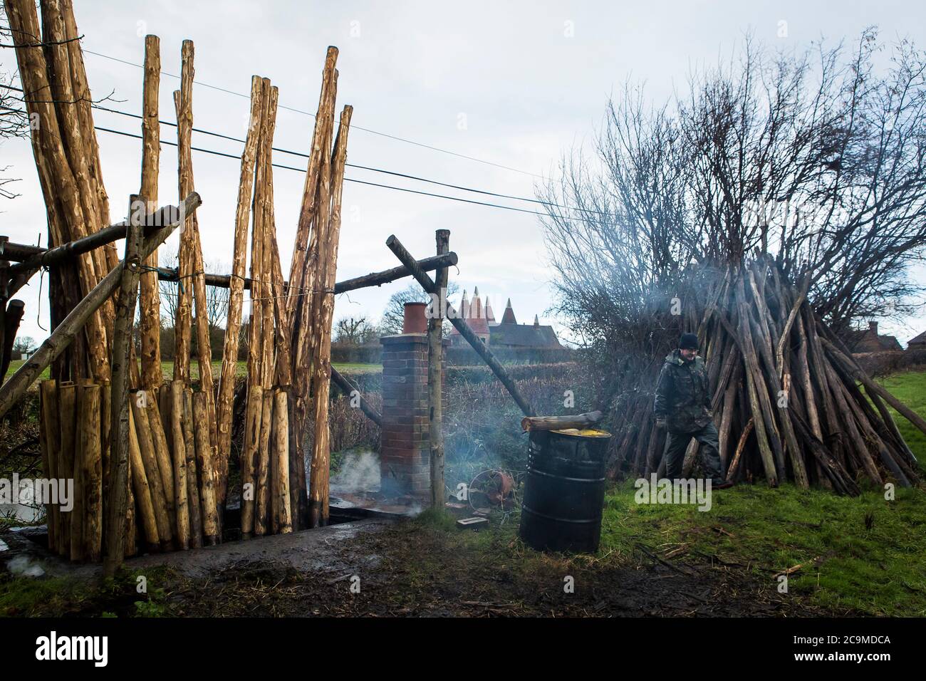 Preserving hop poles made of chestnut wood in creosote to preserve them ...