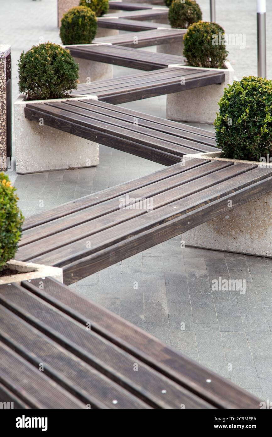 The long benches curved at corners stretch from the edge of the frame ...