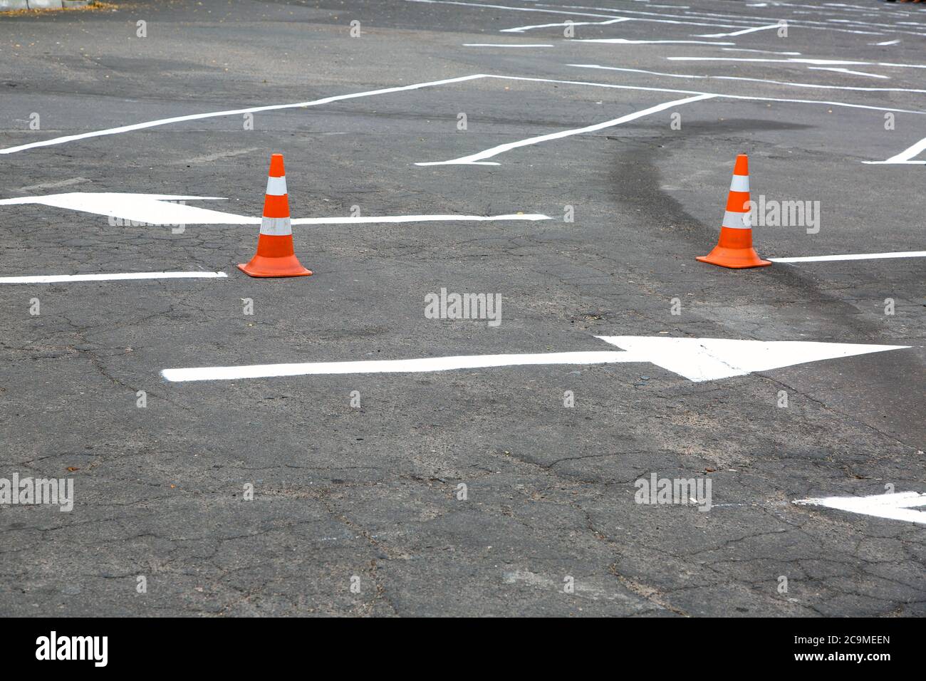 traffic cones enclose a freshly painted marking of a parking space and ...