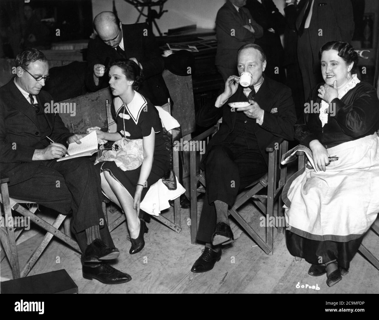 Journalist interviewing JESSIE MATTHEWS on set candid also with ROBERT ...