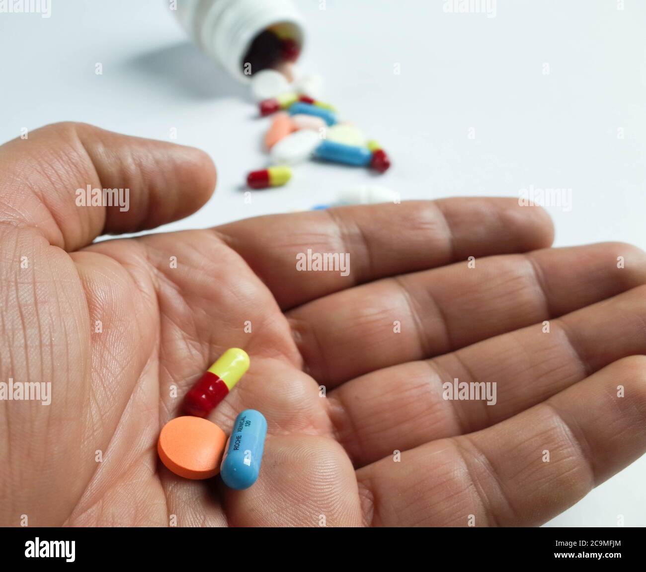 Person pouring pills into hand hi-res stock photography and images - Alamy