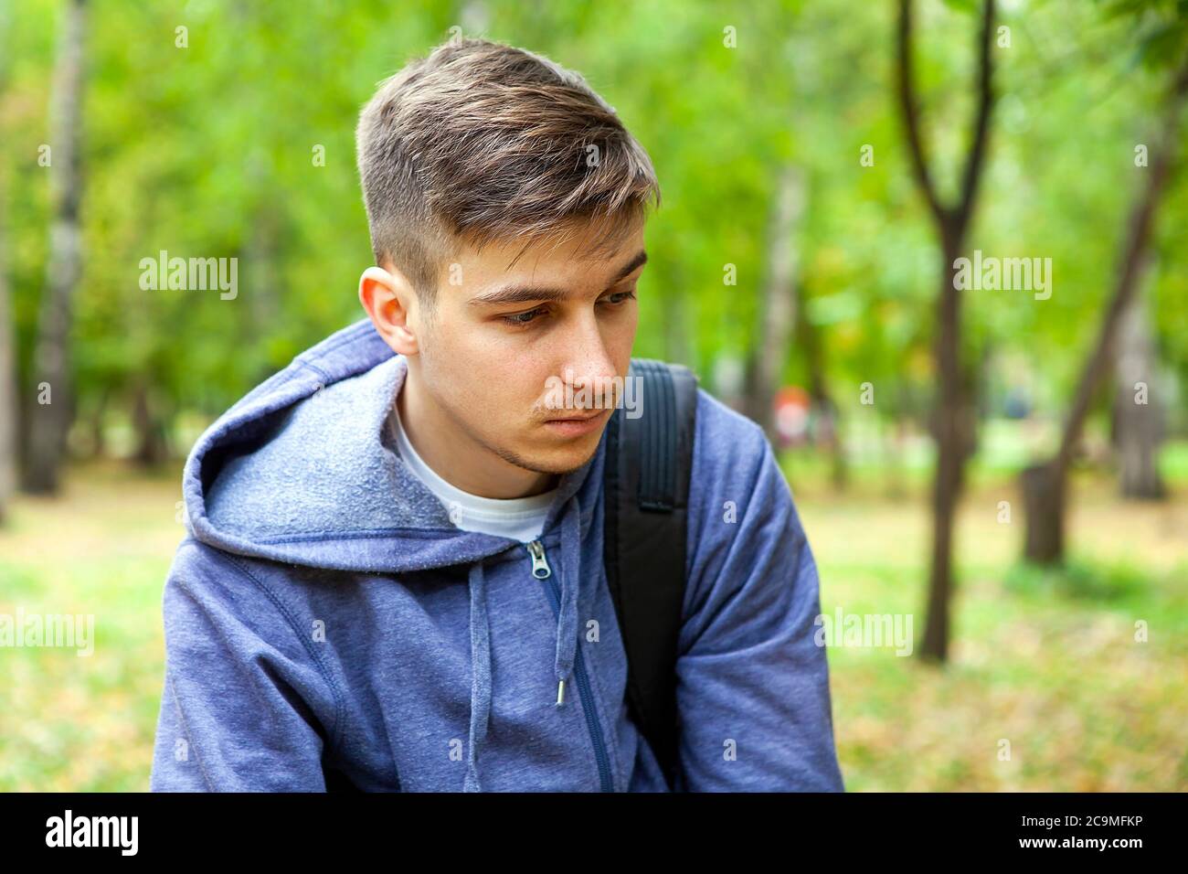 Sad young man outside hi-res stock photography and images - Alamy
